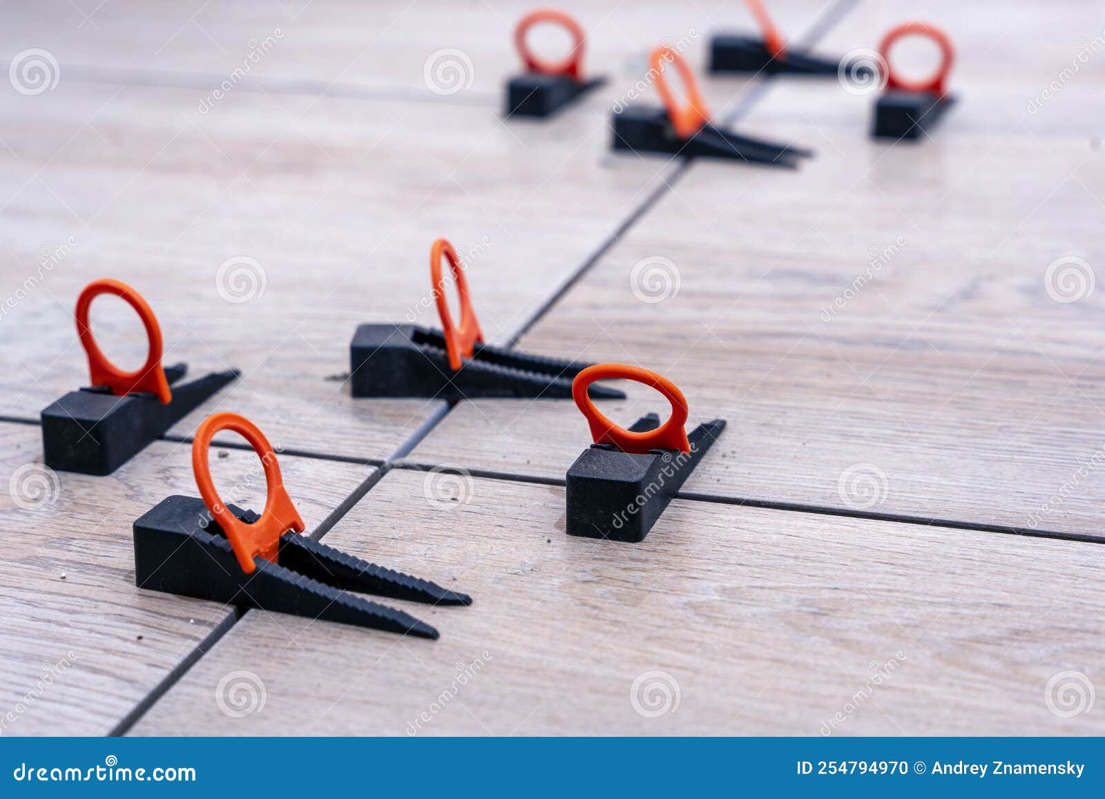 Close-up of the Tile Alignment System Holding Tile in Given Position ...