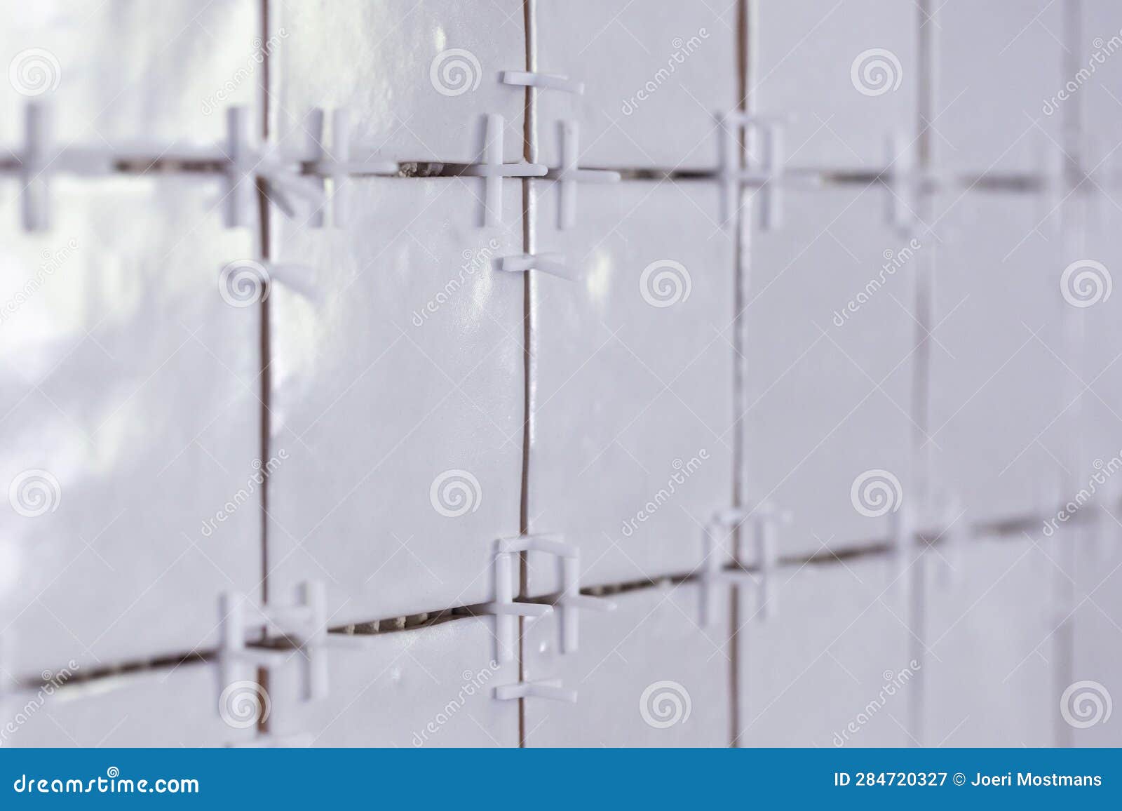 A Close Up of a Tile Wall Under Construction. the Wall is Being Tiled ...