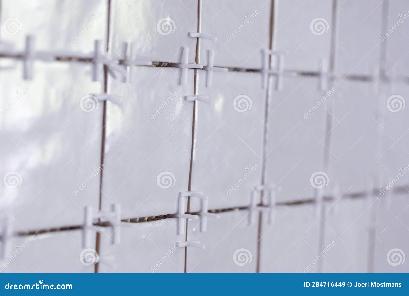 A Close Up of a Tile Wall Under Construction. the Wall is Being Tiled ...