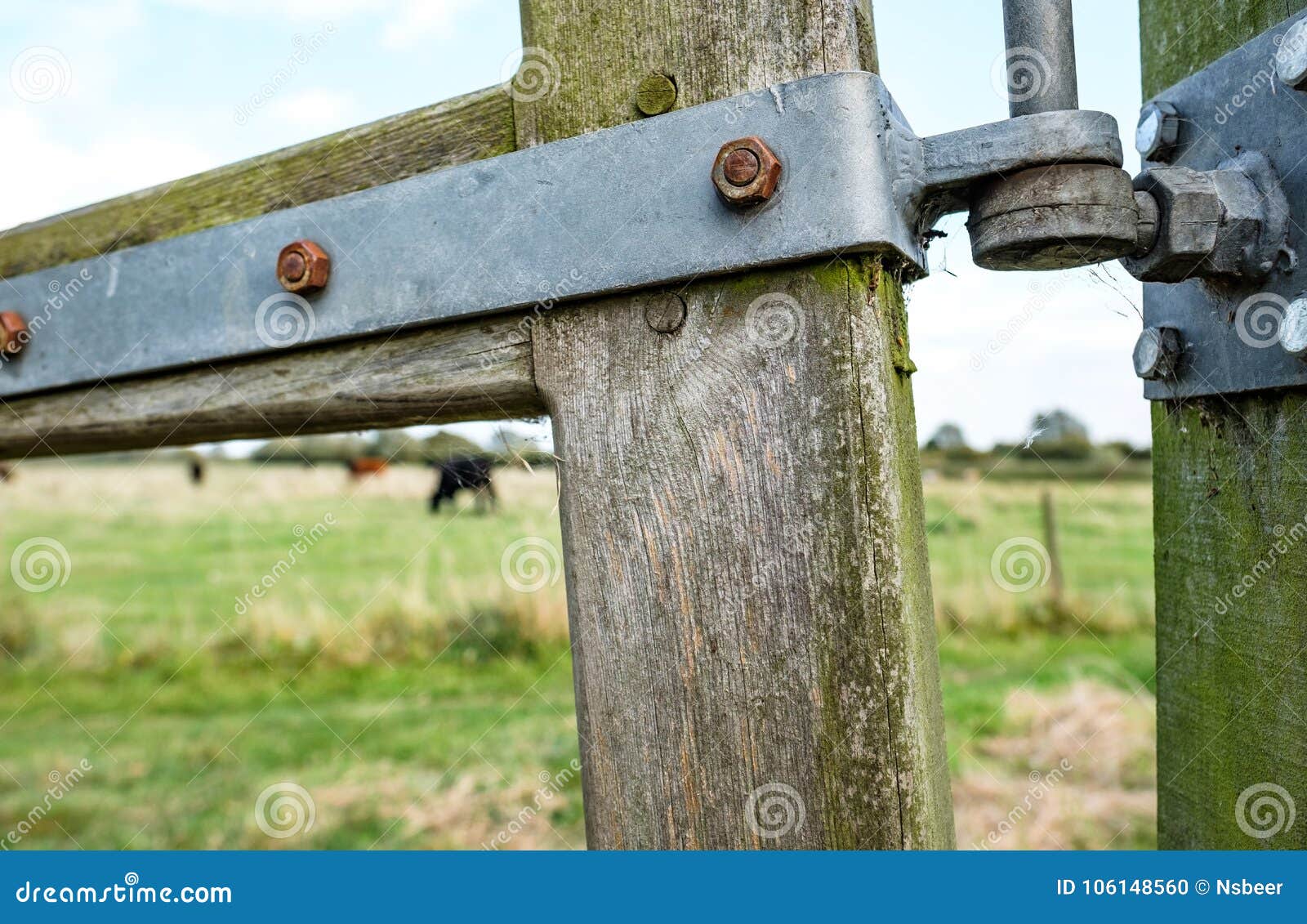 Close-up of a Timber-framed Farm Gate with a Distant View of a Small ...
