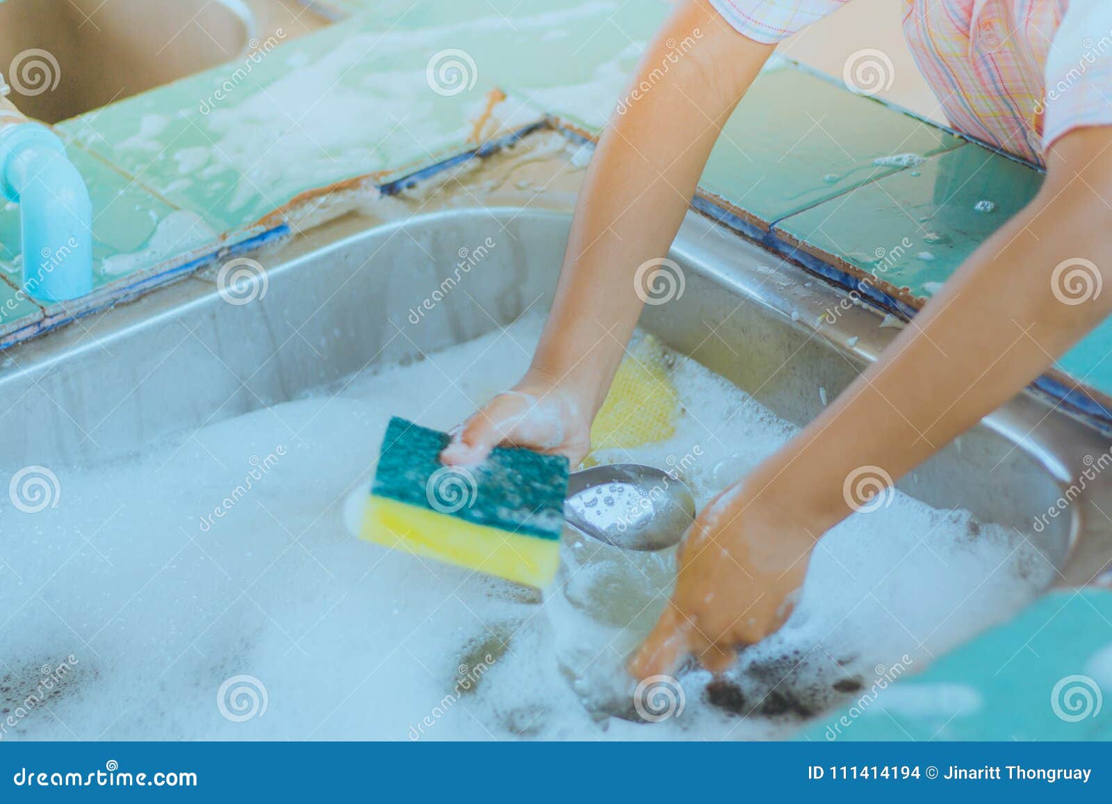 Close Up To Hands of Kindergarten Student is Cleaning a Spoon. Stock ...