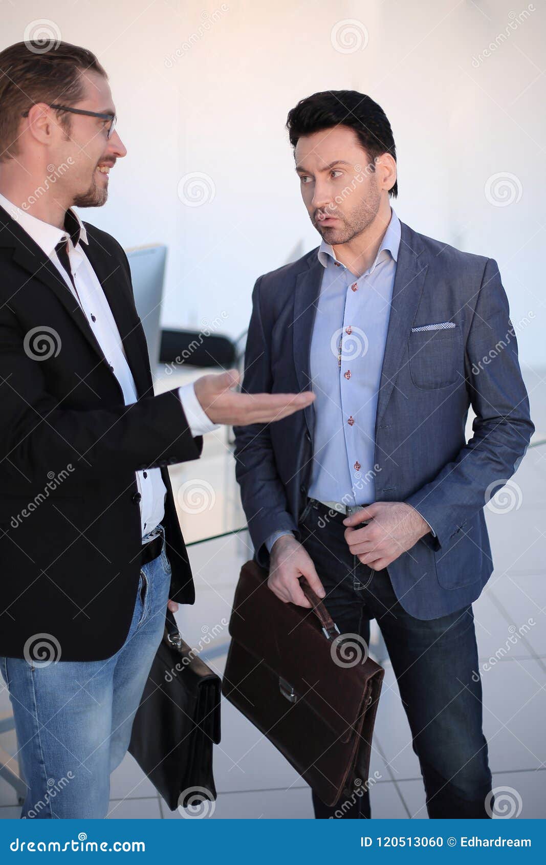 Close Up.two Business Partners Talking in an Office Hallway Stock Photo ...