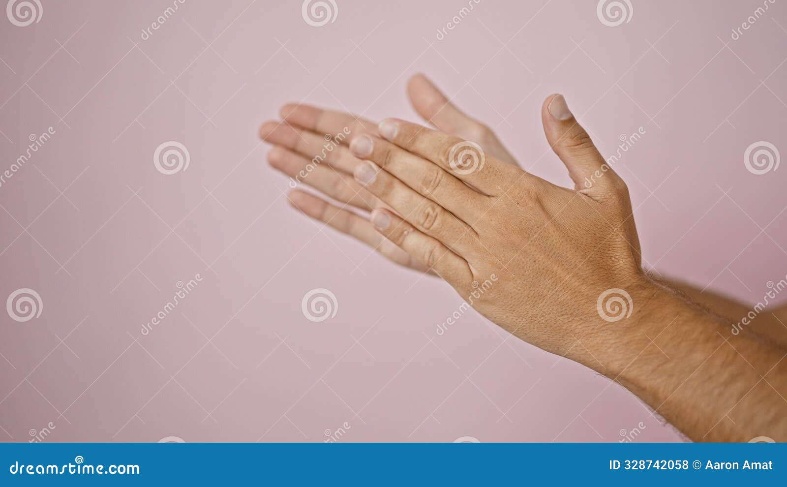 Close-up of Two Clapping Hands Against a Soft Pink Background ...