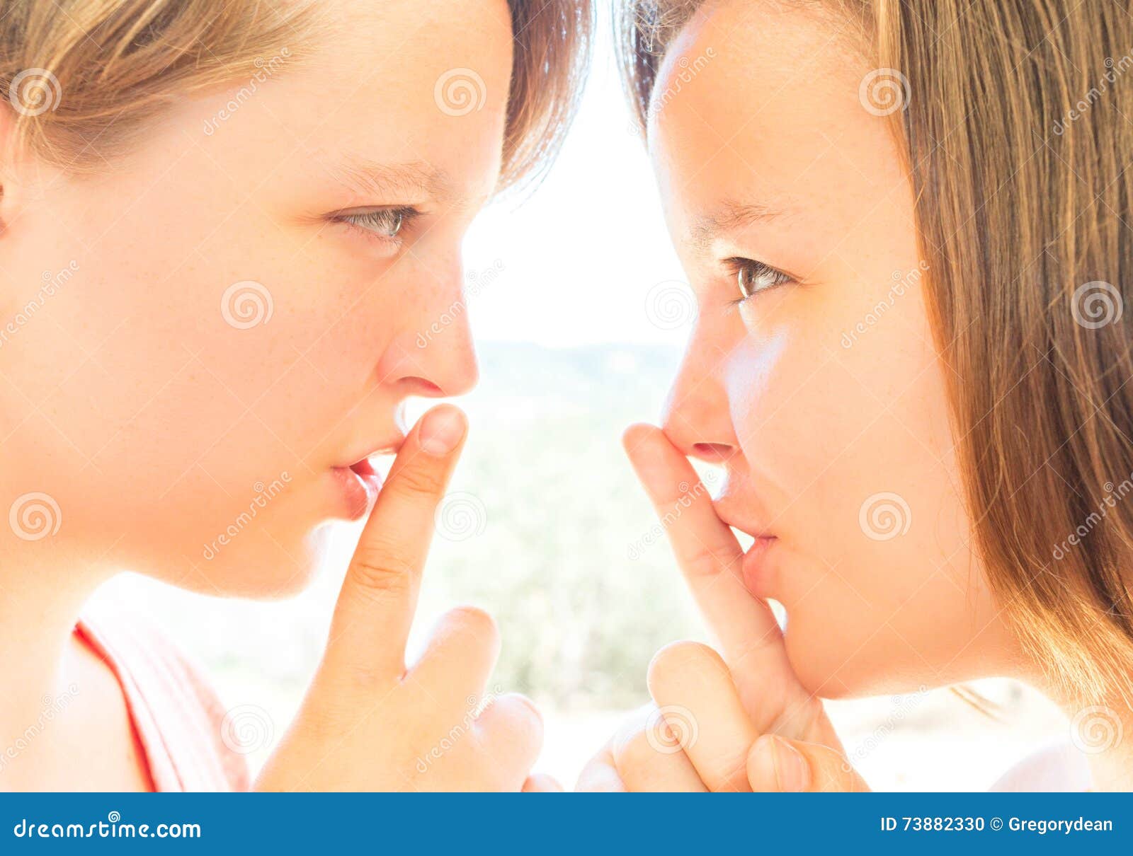 Close Up of Two Cute Girls Asking for Silence Stock Photo - Image of ...