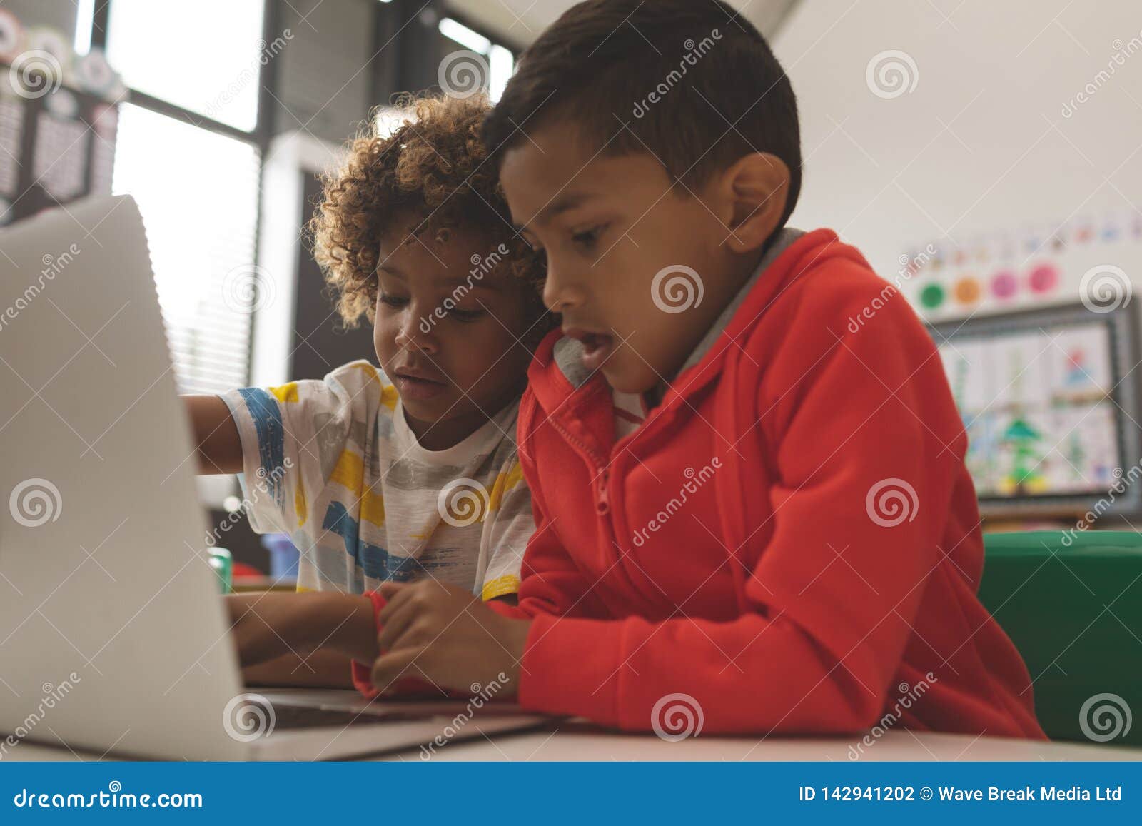 Close-up of Two Handsome School Boys Working on One Laptop in Classroom ...