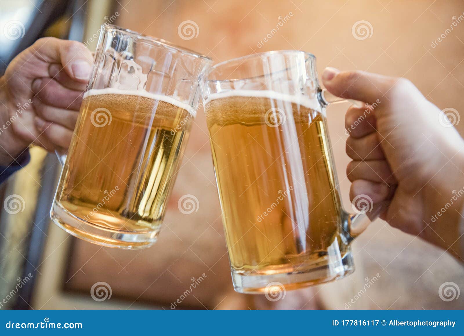 Two men toasting with beer stock image. Image of clinking - 177816117