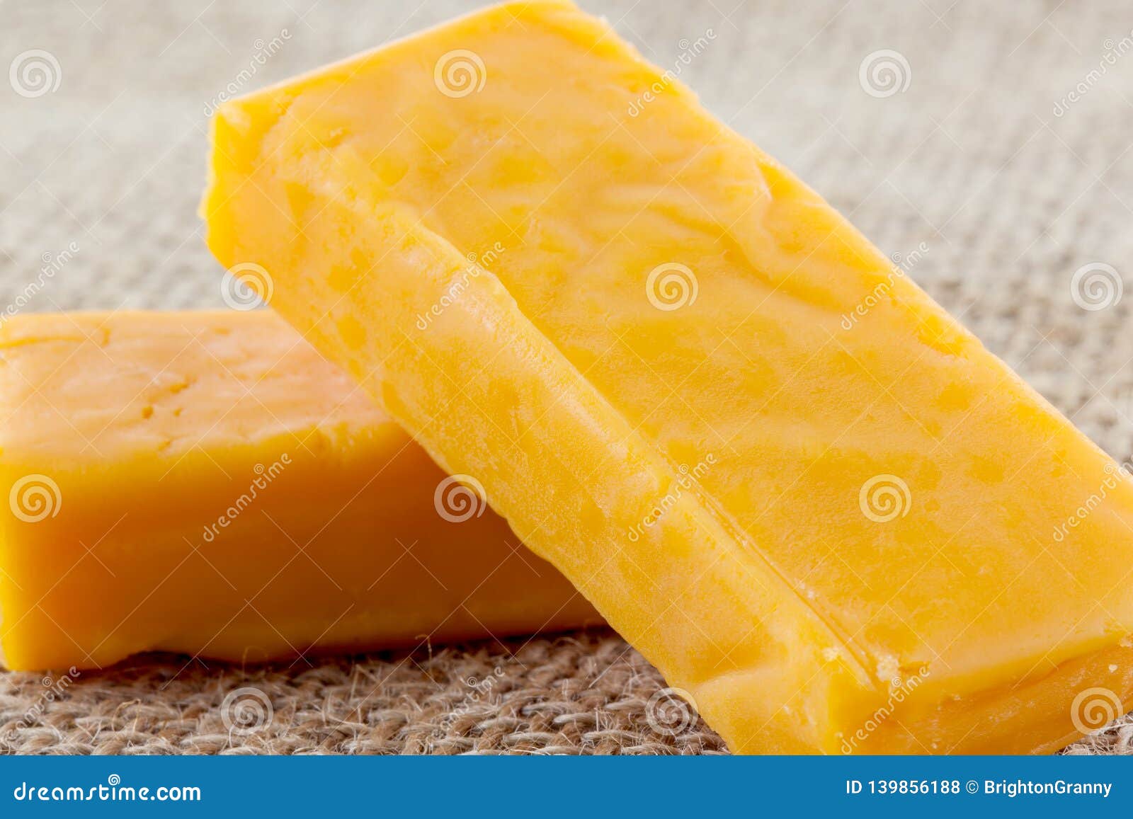 A Close Up of Two Small Cheddar Cheese Pieces. Stock Photo - Image of ...
