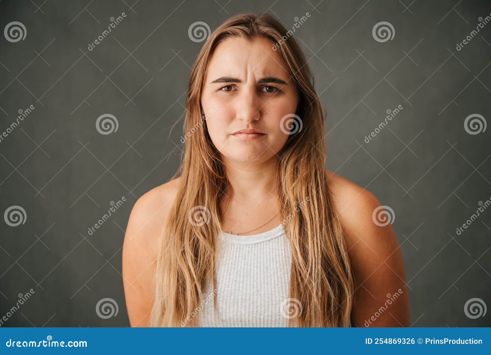 Close Up Of Unhappy Caucasian Female With Long Blond Hair Outraged