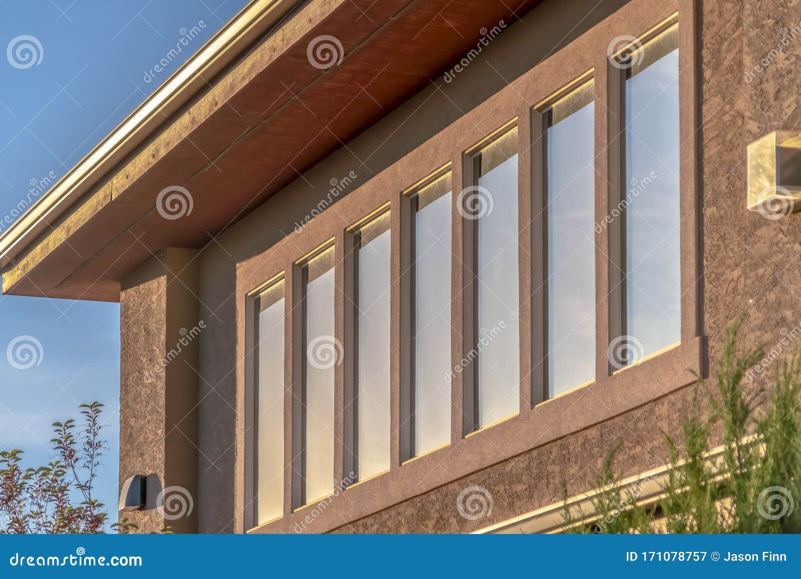 Close Up of Upper Storey of Home with Rectangular Windows Lining the ...