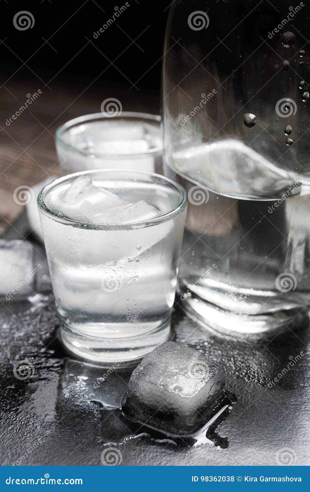 Close-up View of Bottle Vodka with Glasses Standing on Ice Black Stock ...