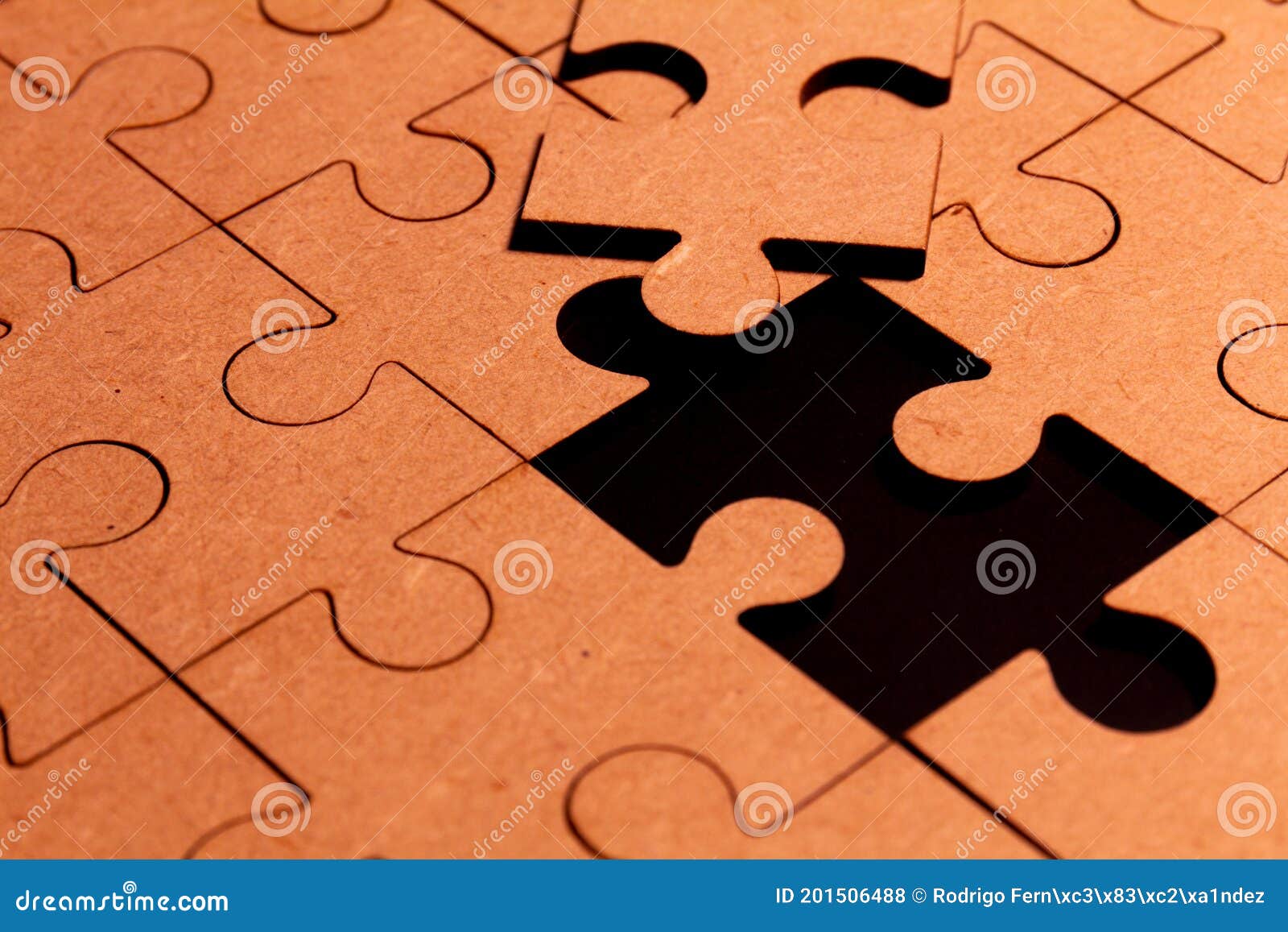 Close Up View of a Brown Puzzle with One Piece Missing Stock Photo ...