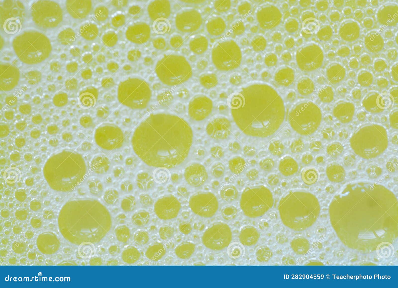 A Close-up View of Bubbles on Yellow Washing Liquid, Creating a Bubbly ...