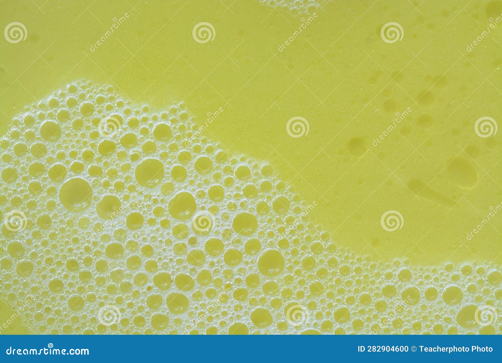A Close-up View of Bubbles on Yellow Washing Liquid, Creating a Bubbly ...