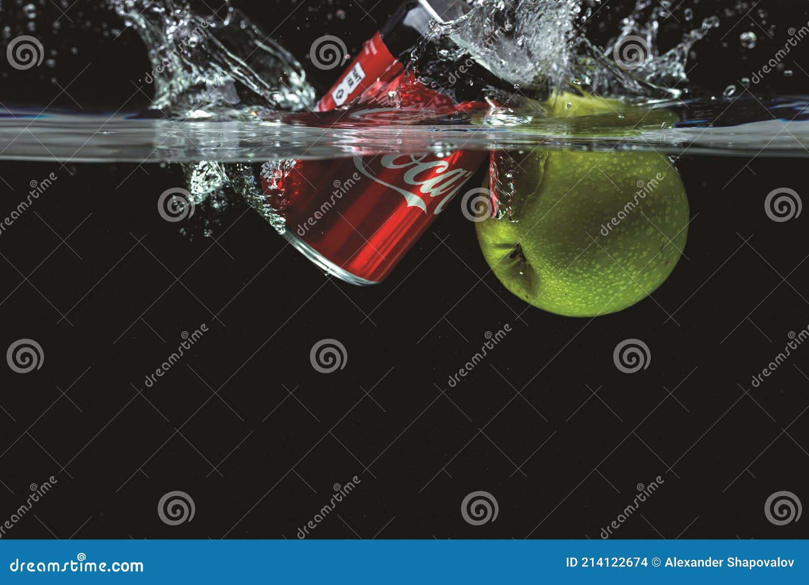 Close Up View of Cans of Coca Cola and Apple Falling into Water with ...
