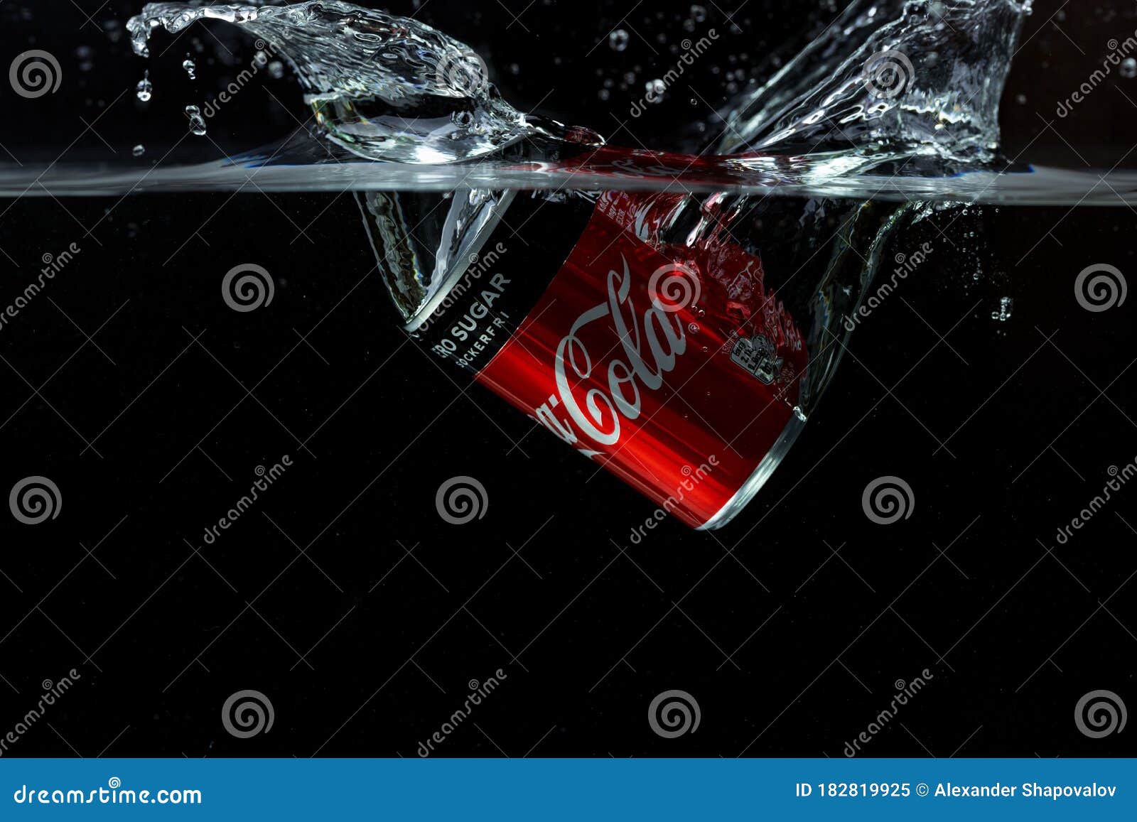 Close Up View of Cans of Coca Cola Falling into Water with Spray ...