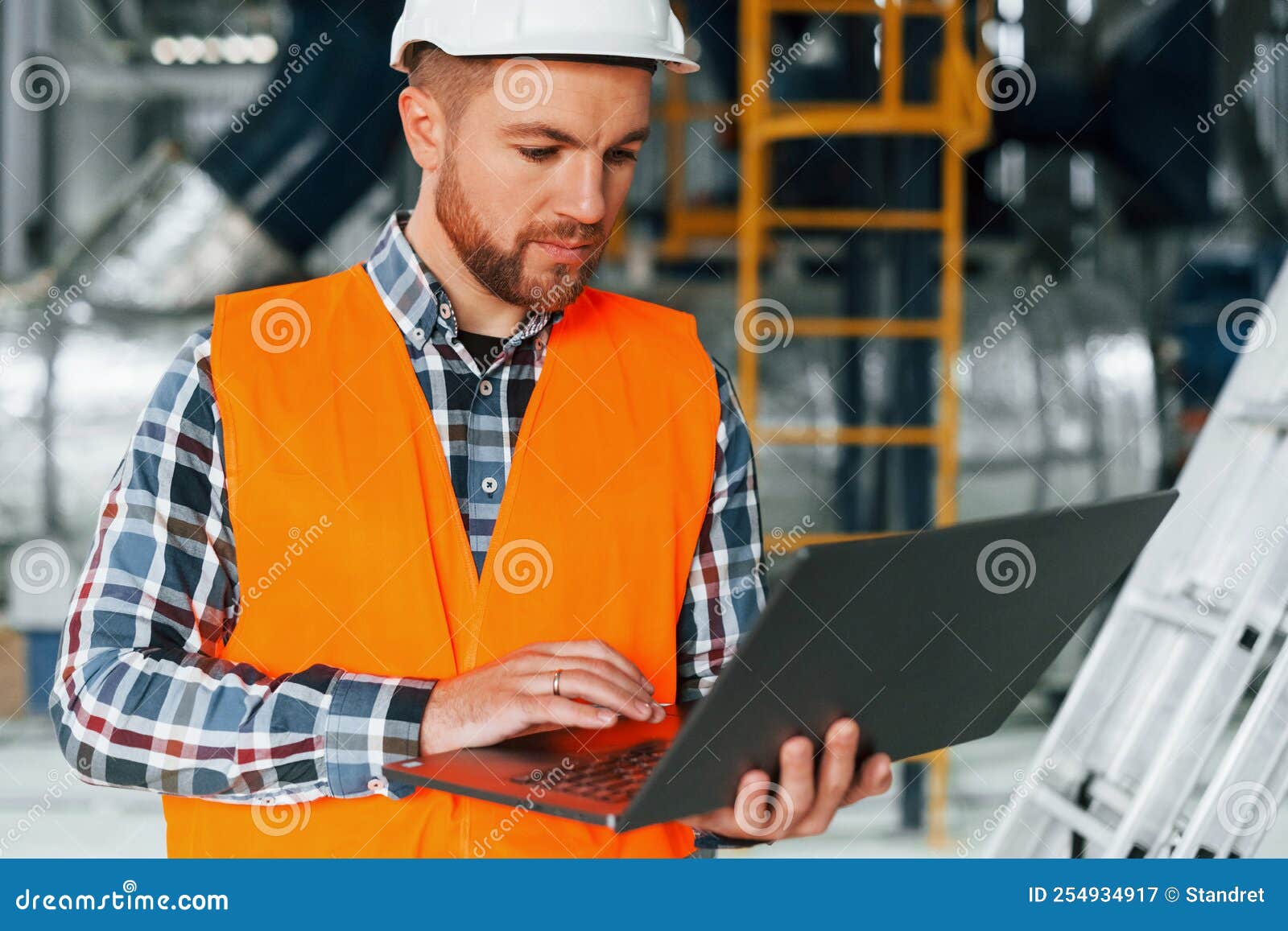 Close Up View. Construction Worker in Uniform is in the Factory Stock ...