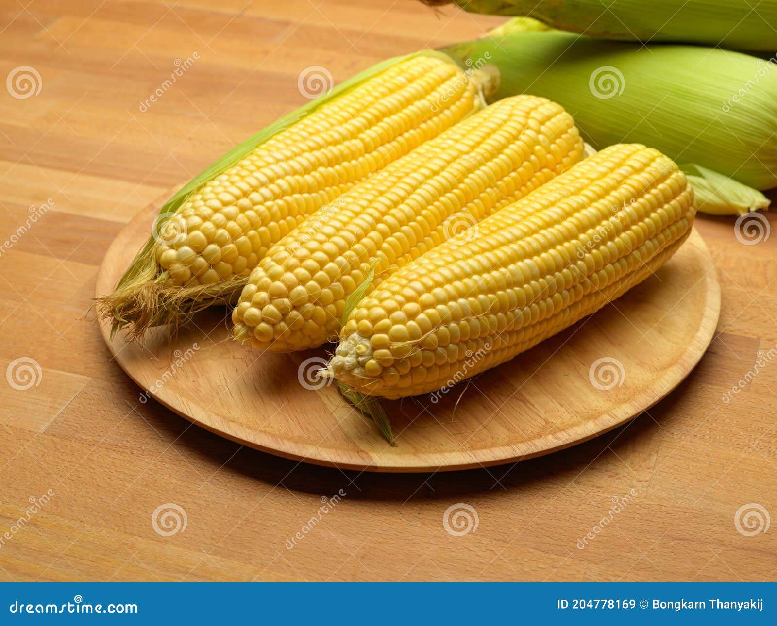 Close Up View of Corns and Corn on the Cop on Wooden Tray on Wooden ...