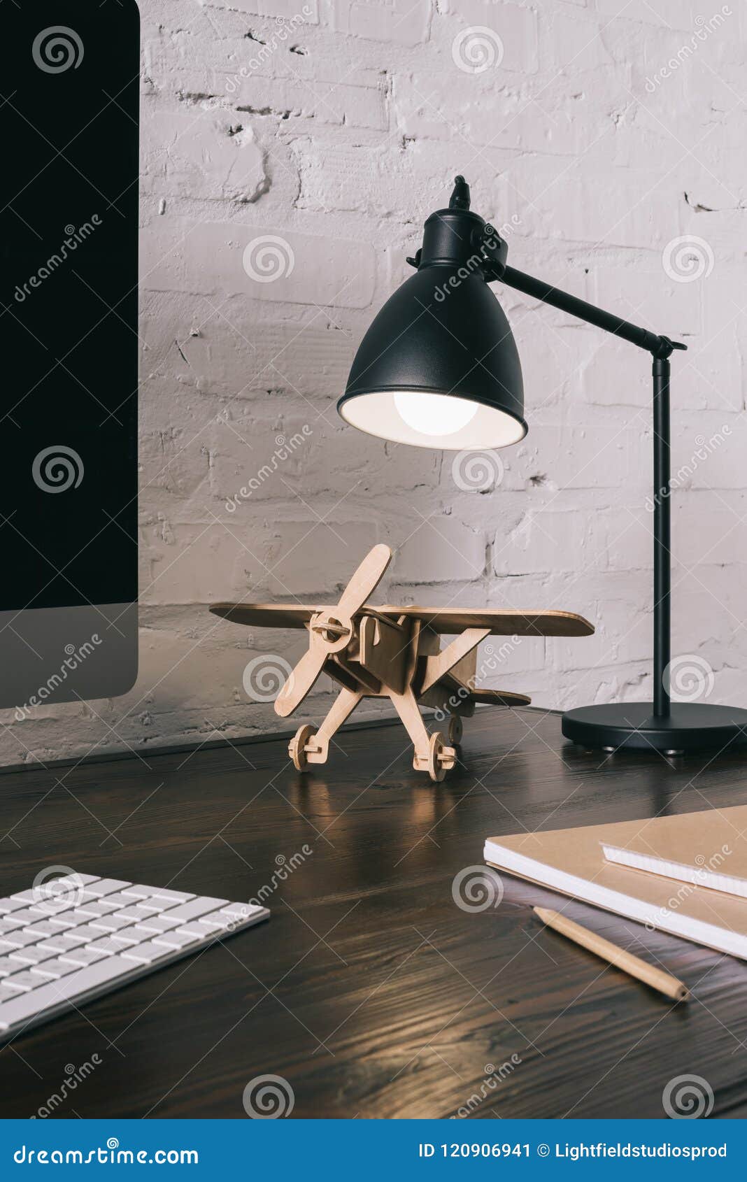 Close-up View of Desktop Computer with Black Screen and Wooden Plane ...