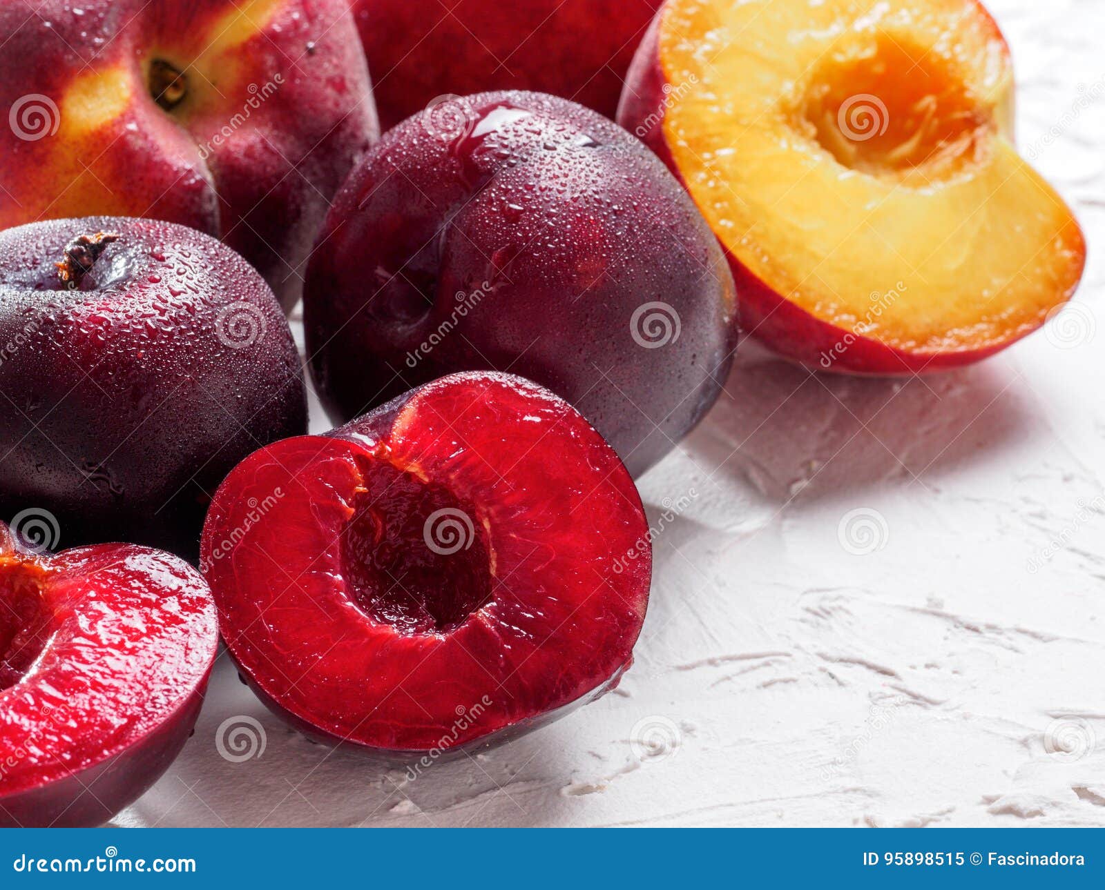 Close Up View of Fresh Plum and Peach on White Concrete Background ...
