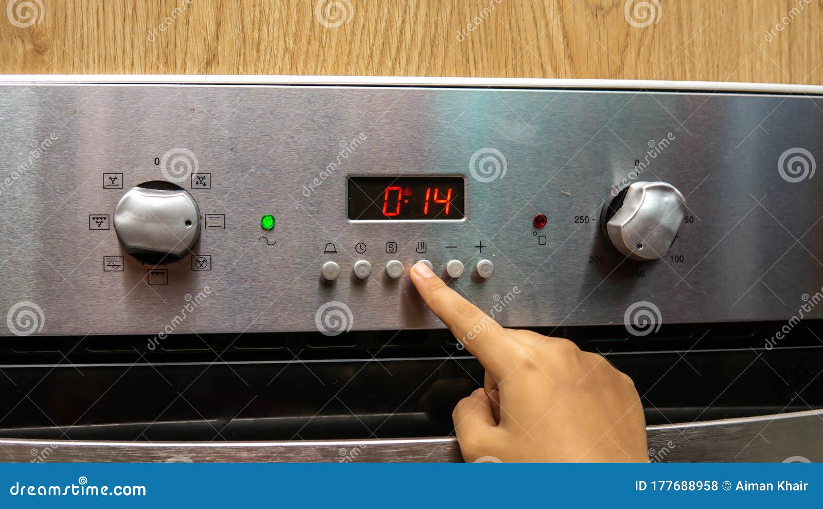 Close Up View of Girl Hand Setting Up the Timer Delay for Baking at the ...