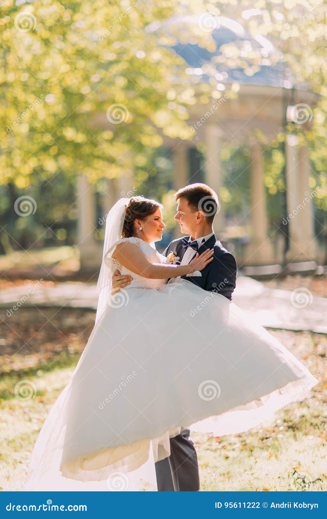 The Close-up View of the Groom Carrying the Bride at the Background of ...