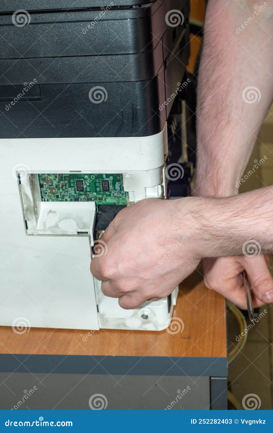 Close-up View of the Hands of the Master Disassembling the Printer ...