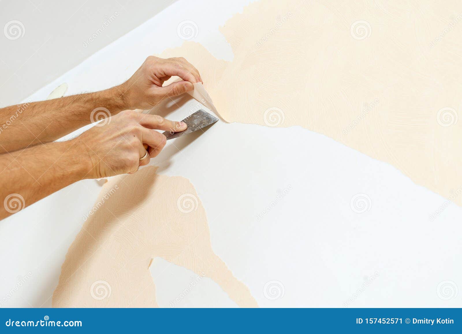 Close-up View on Hands with a Scraper in the Process of Removing ...