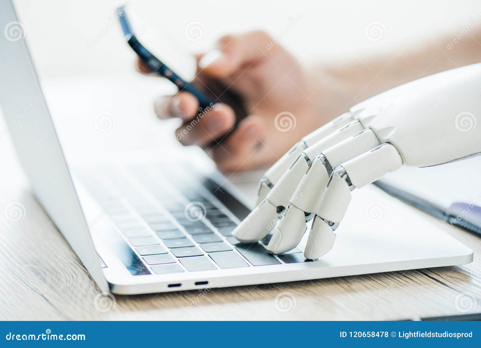 Close-up View of Human and Robot Hands Using Smartphone and Laptop ...