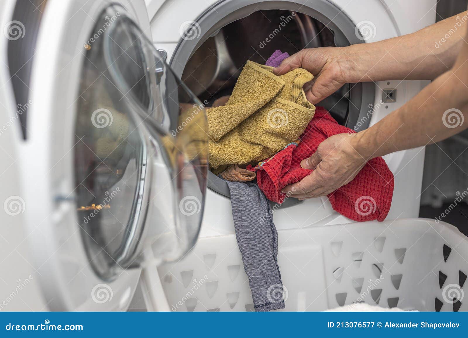Close Up View of Man Loading Clothes To Washing Machine. Stock Image ...