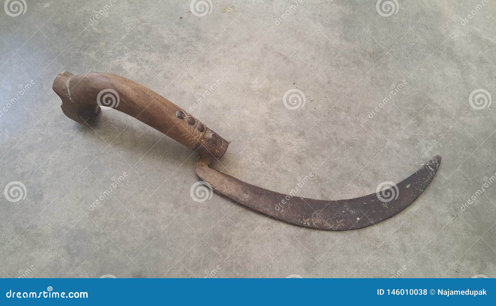 Close-up View of an Old Sickle Reaping-hook on the Concrete Surface ...