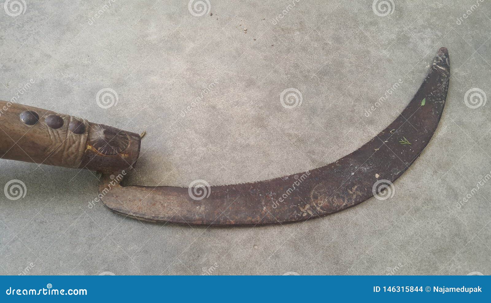 Close-up View of an Old Sickle Reaping-hook on the Concrete Surface ...