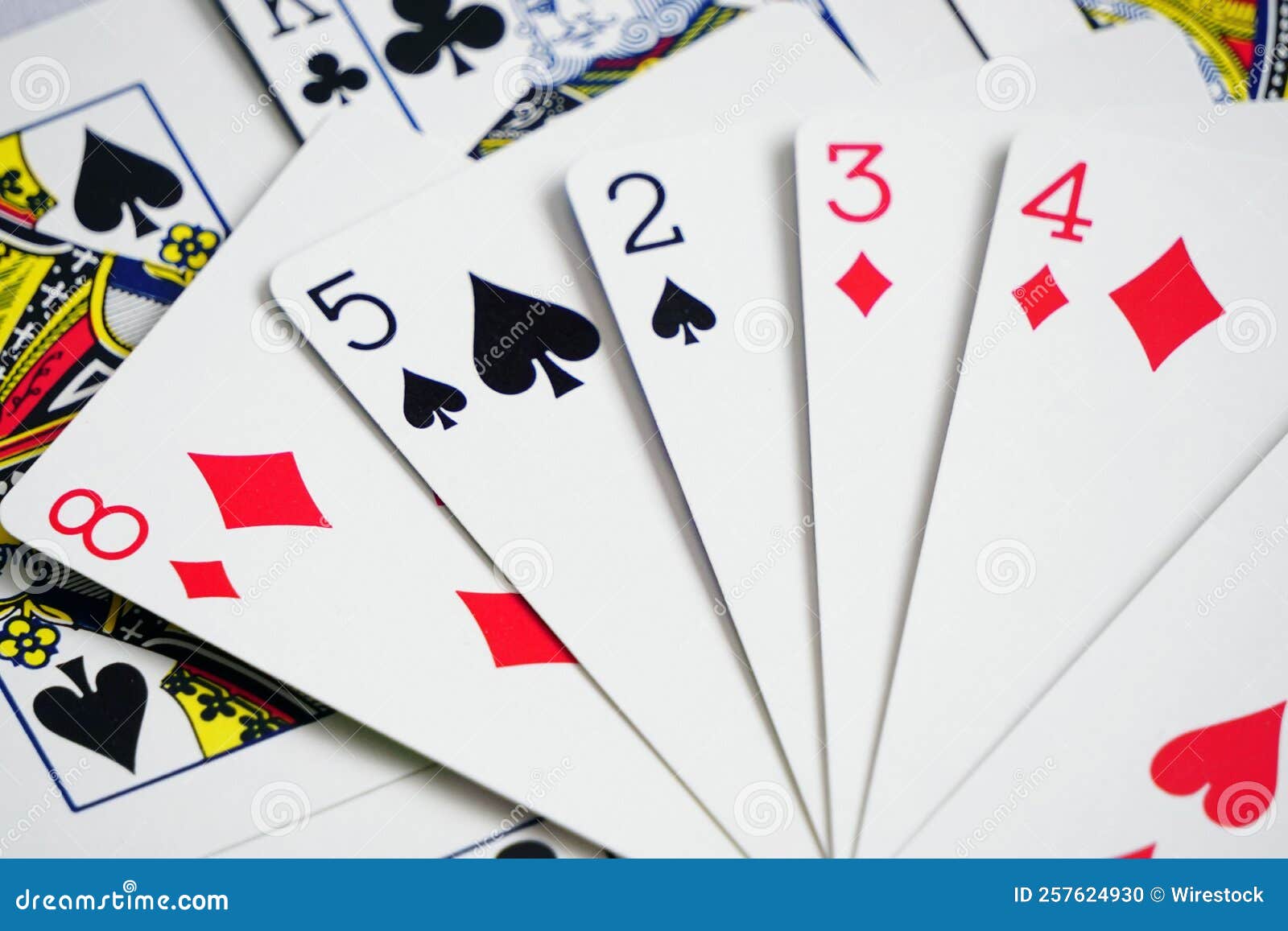 Close-up View of a Pile of Playing Cards Over the White Surface ...