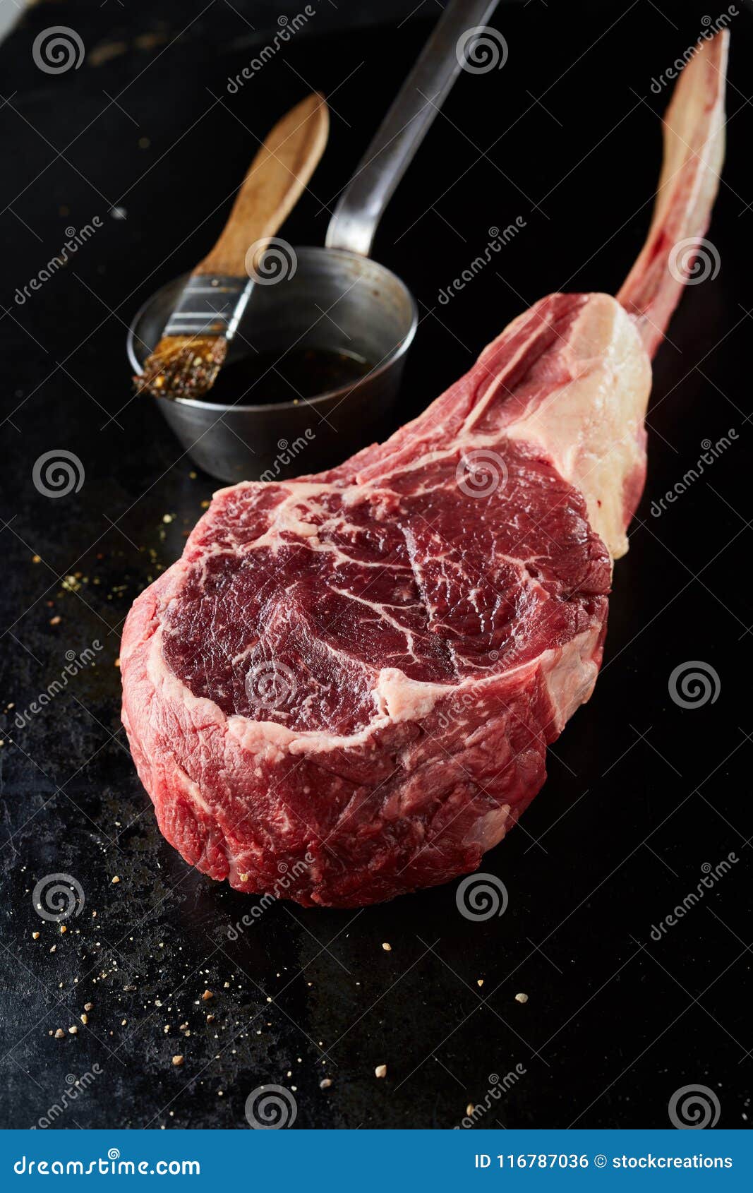 Close Up View of Raw Rib Eye Tomahawk Steak on Black Table Stock Photo ...