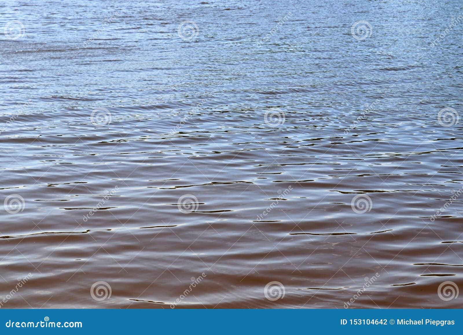 Close Up View on a Reflective Water Surface with Waves and Ripples in ...