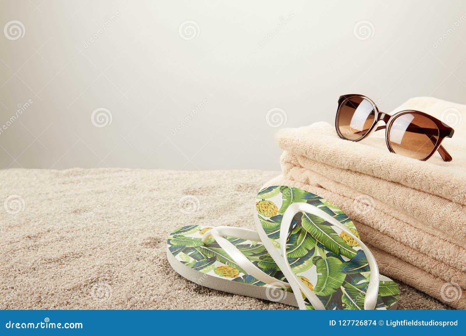 Close Up View of Stack of Towels, Sunglasses and Summer Flip Flops on ...