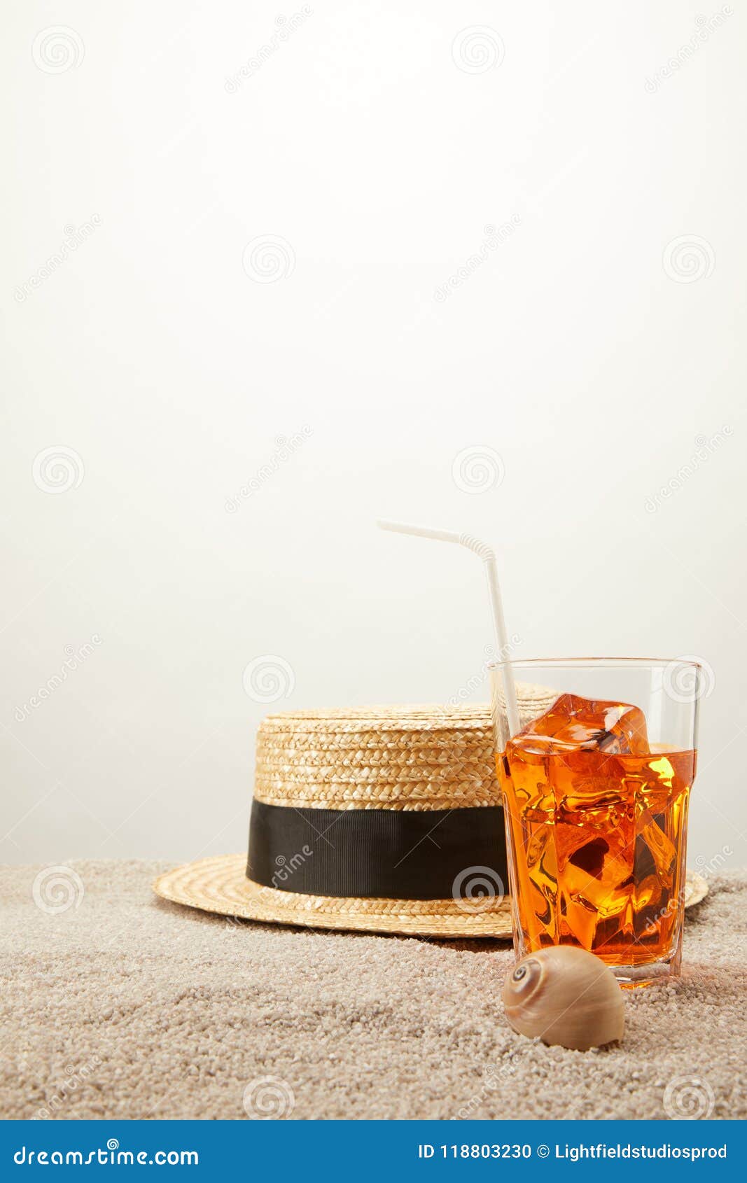 Close Up View of Straw Hat and Refreshing Cocktail with Ice on Sand on ...