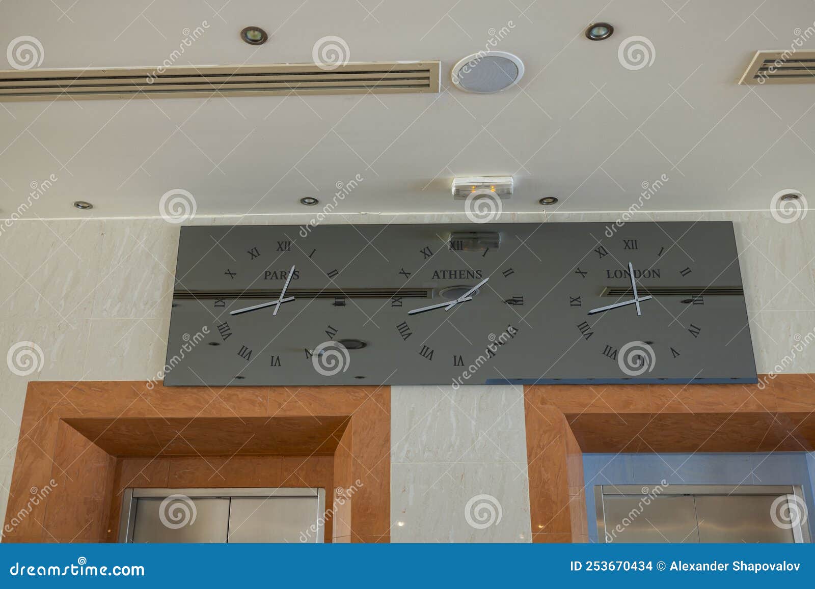 Close Up View of Word Clock for Different Cities Over Elevator Doors at ...