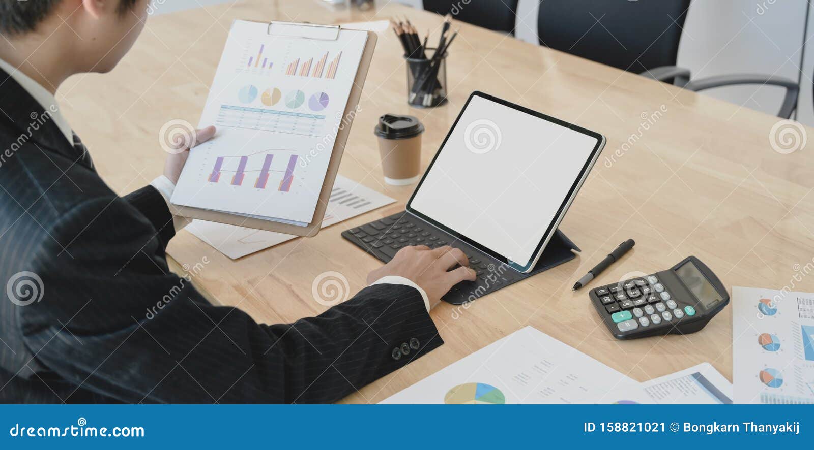 Young Businessman Working on His Current Project while Using Tablet and ...