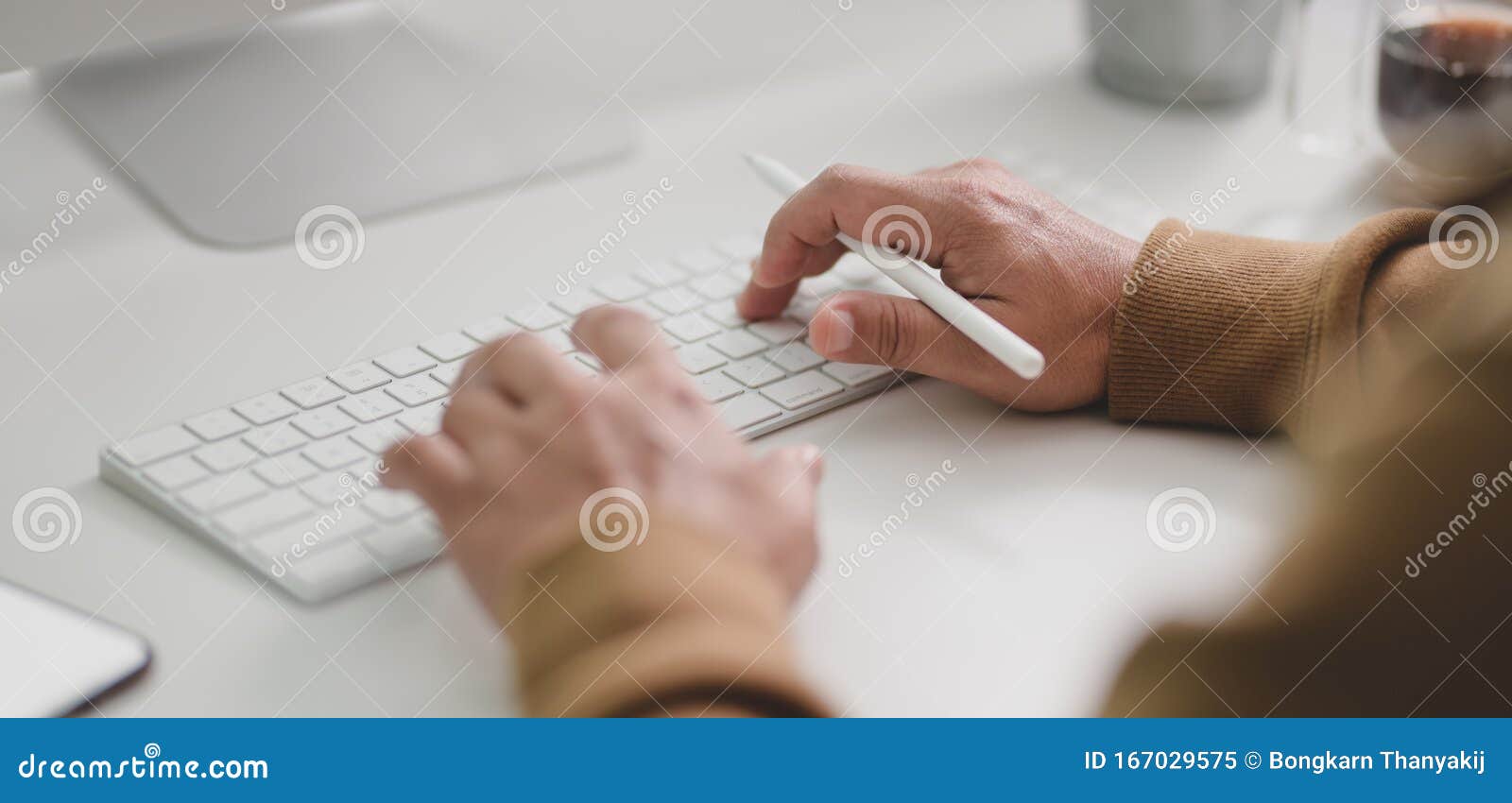 Close-up View of Young Man Typing on Keyboard Computer while Working on ...