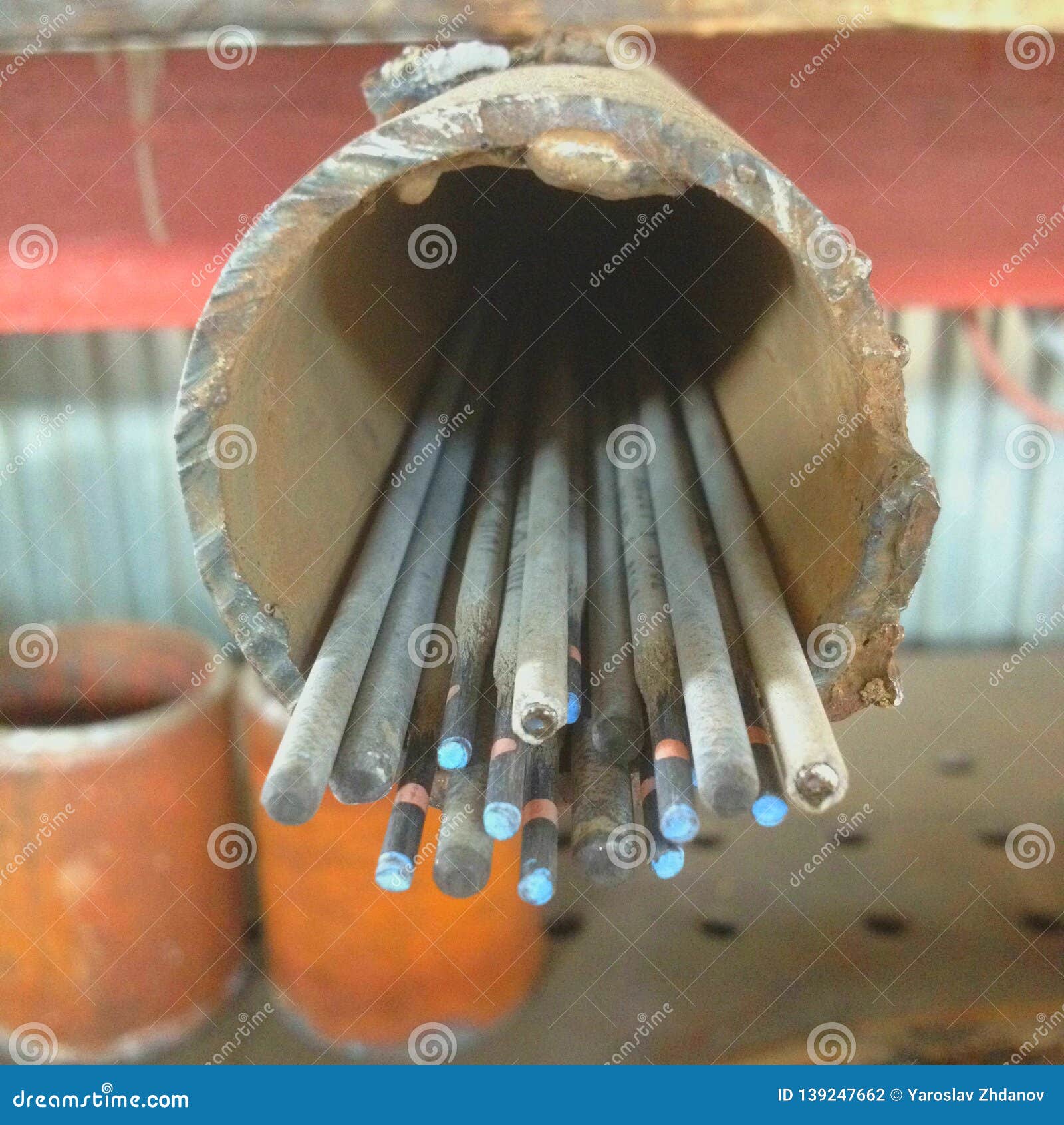 Electrodes are Placed in a Piece of Rusty Pipe in the Welding Shop ...