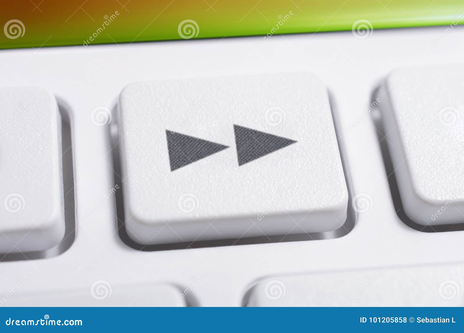 Close Up of a White Fast Forward Button of a White Remote Control for a ...