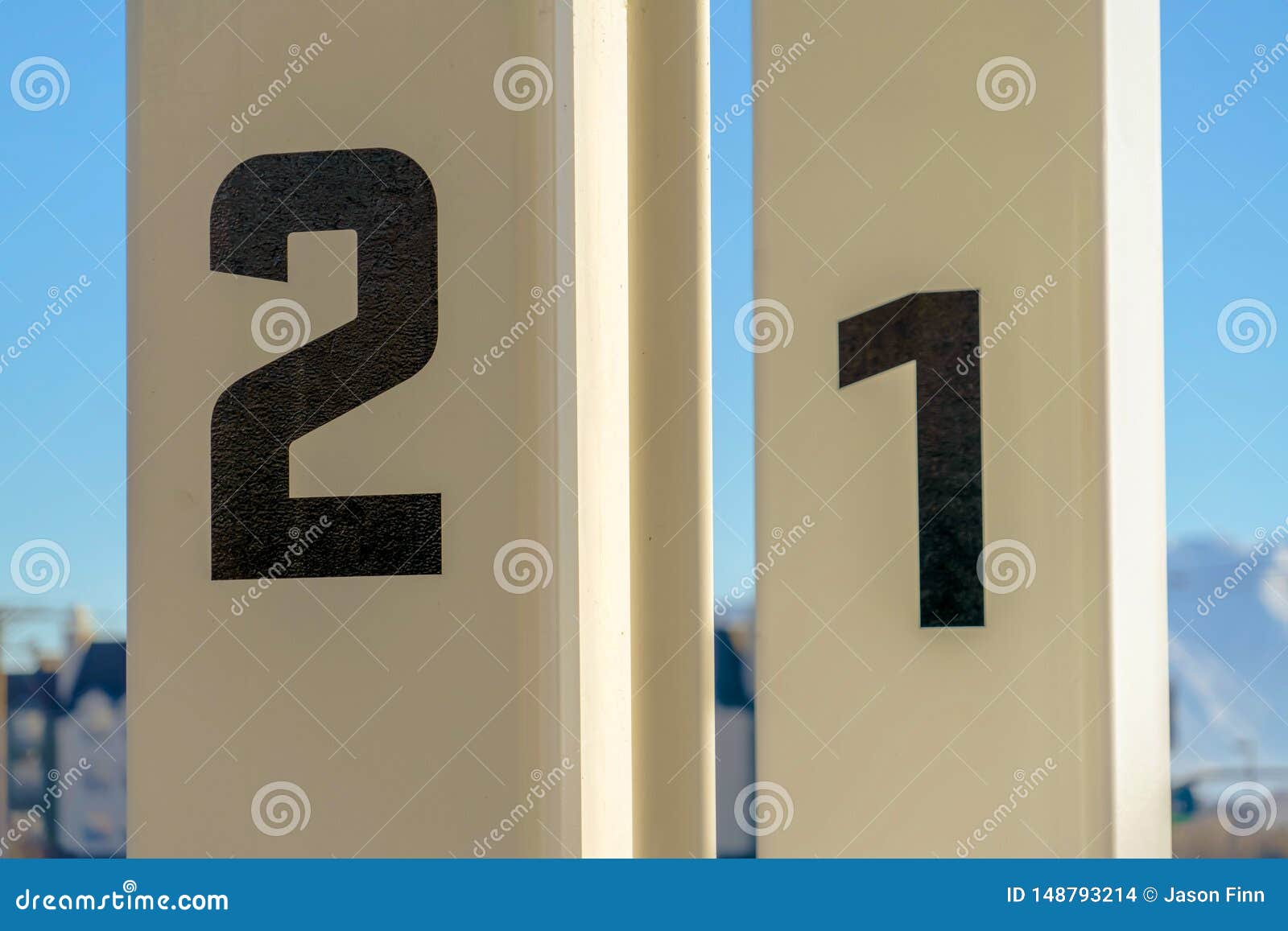 Close Up of White Rectangular Posts with Numbers Painted on the Surface ...