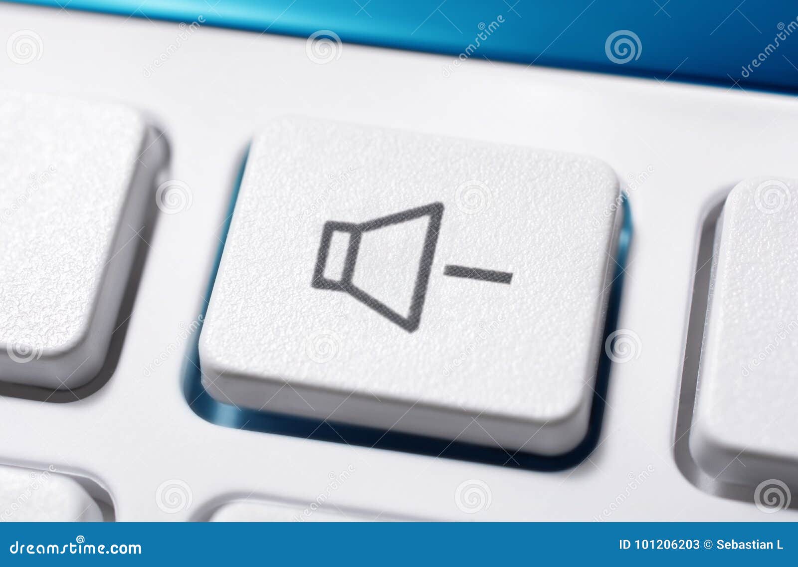 Close Up of a White Volume Down Button of a White Remote Control for a ...