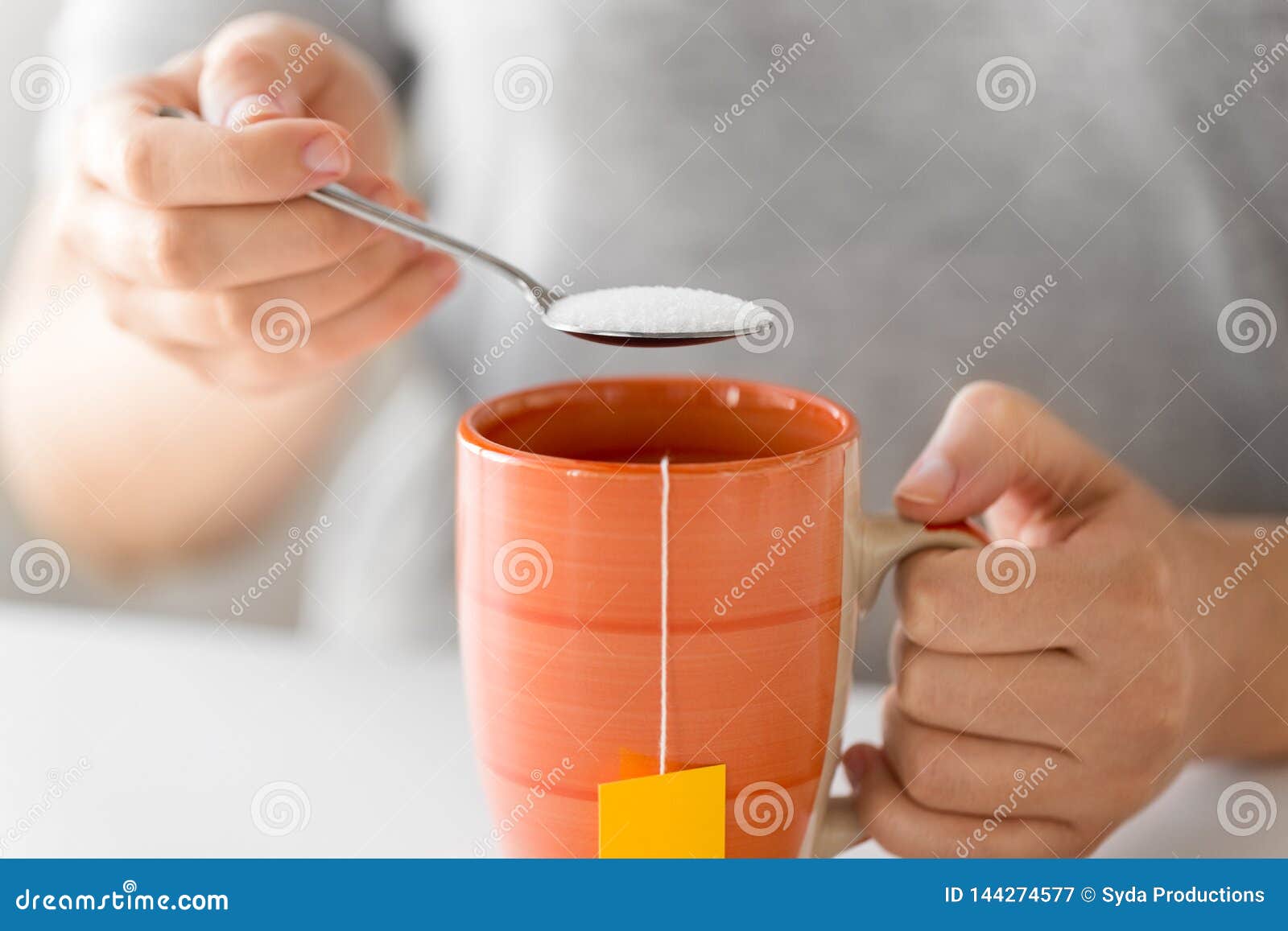 Close Up of Woman Adding Sugar To Cup of Tea Stock Image - Image of ...