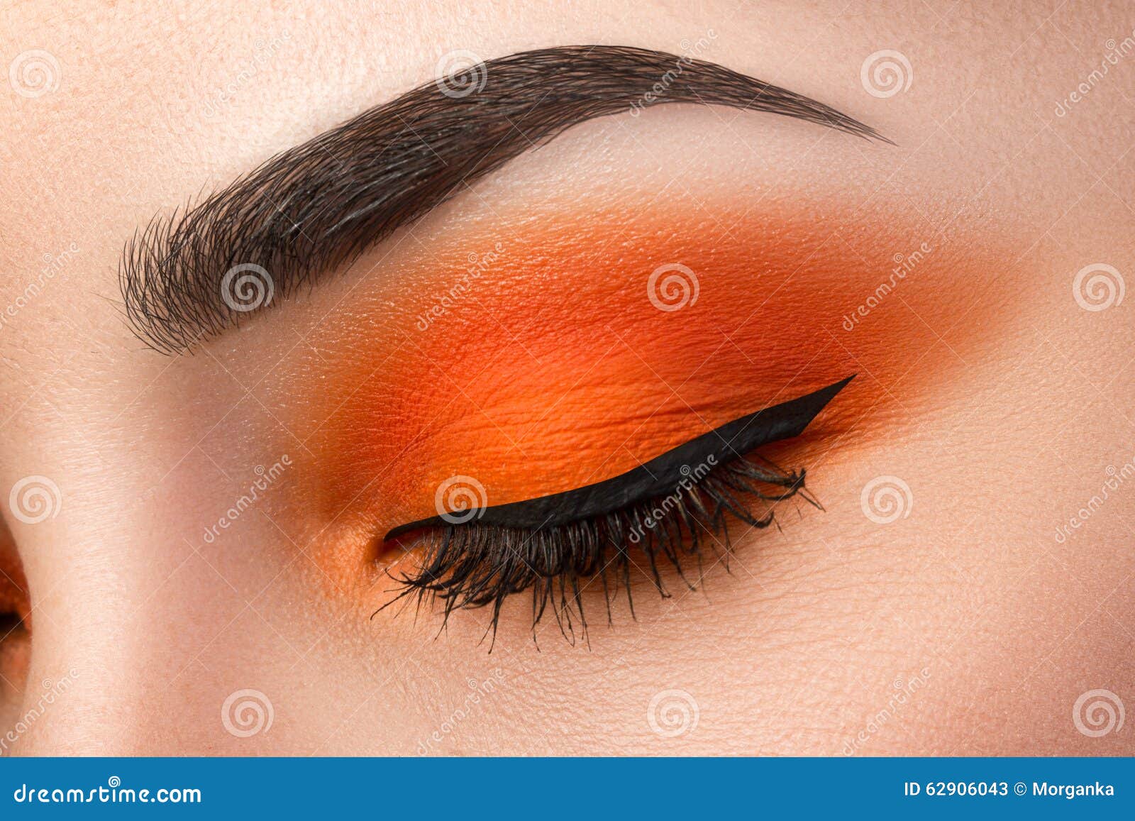 Close Up Of Woman Eye With Beautiful Orange Smokey Eyes With Black