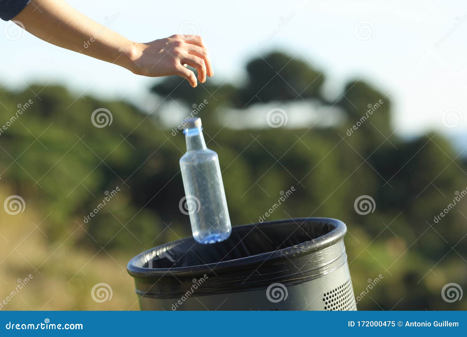 Close Up of a Woman Hand Throwing a Bottle into Bin Stock Image - Image ...