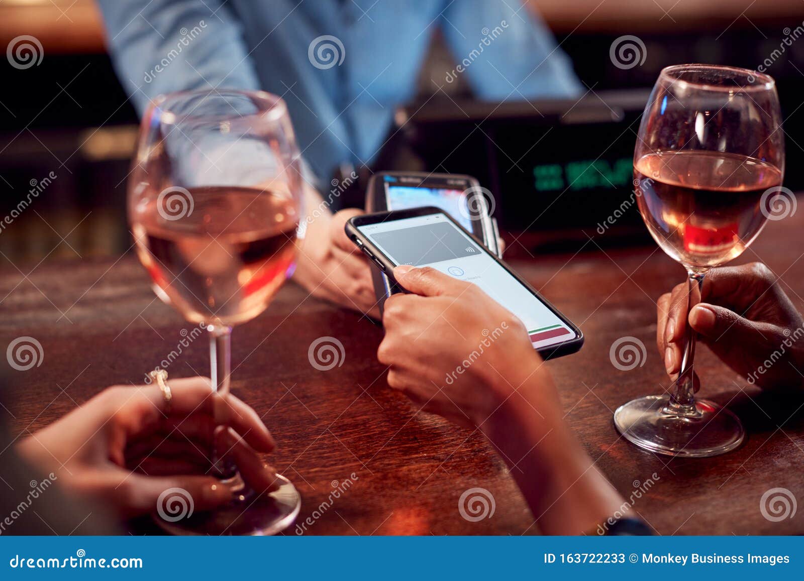 Close Up of Woman Paying for Drinks at Bar Using Contactless App on ...