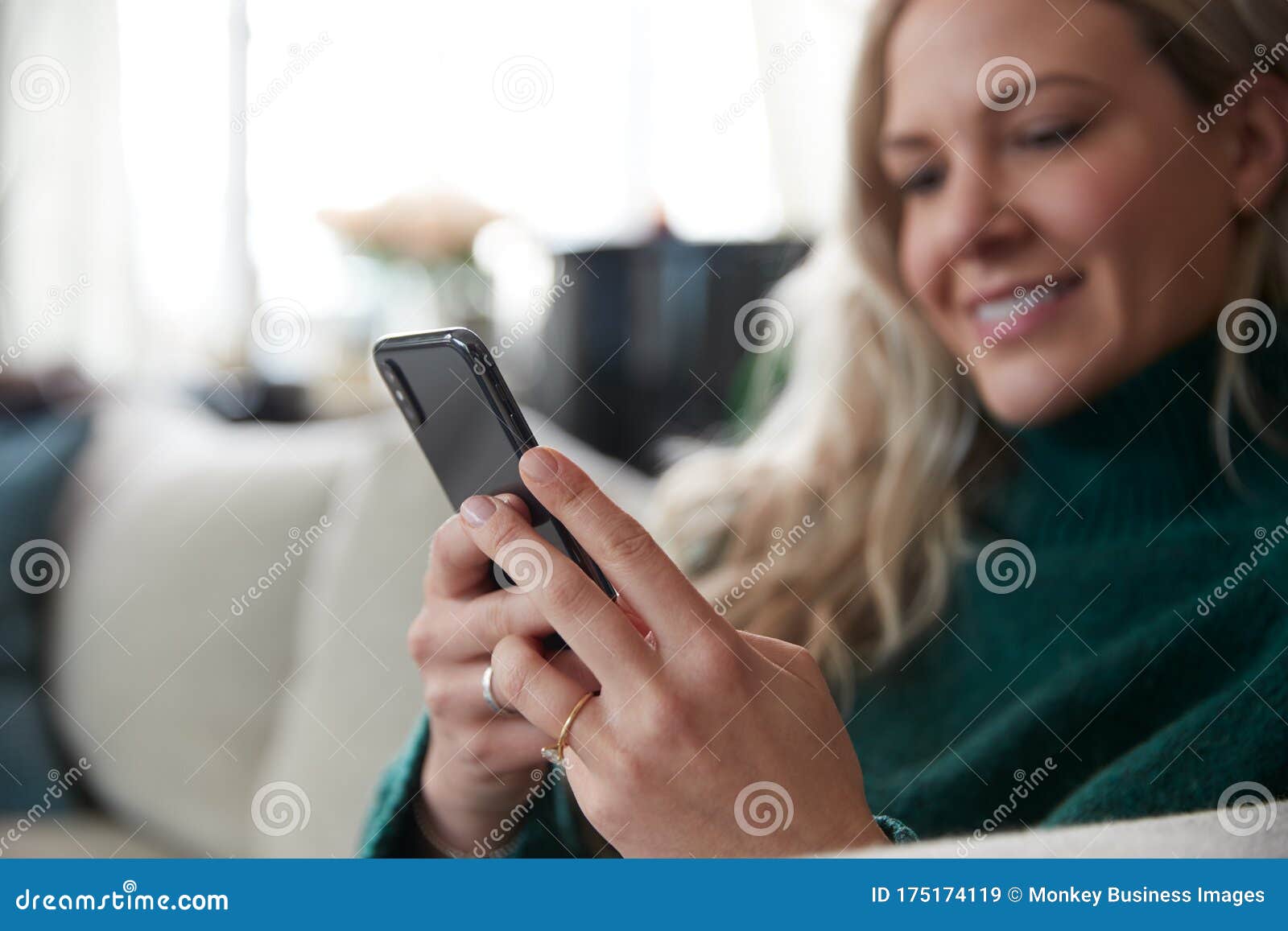 Close Up of Woman Relaxing on Sofa at Home Using Mobile Phone Stock ...