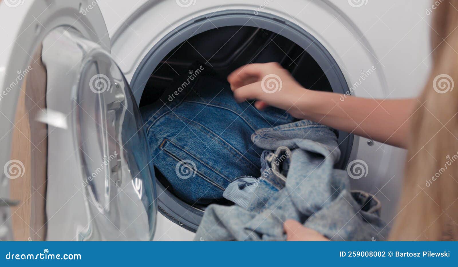 Close-up of Woman S Hands Pulling Clothes Out of Laundry, Empties ...