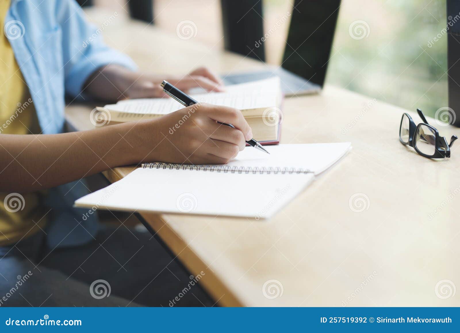 Close Up of Woman Studying, Reading Book, and Taking Notes. Stock Photo ...